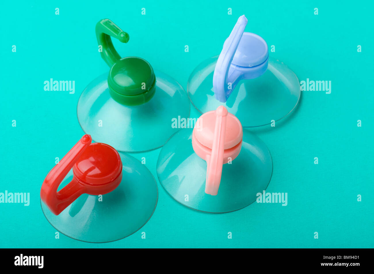 object on green - Colored plastic hook Stock Photo - Alamy