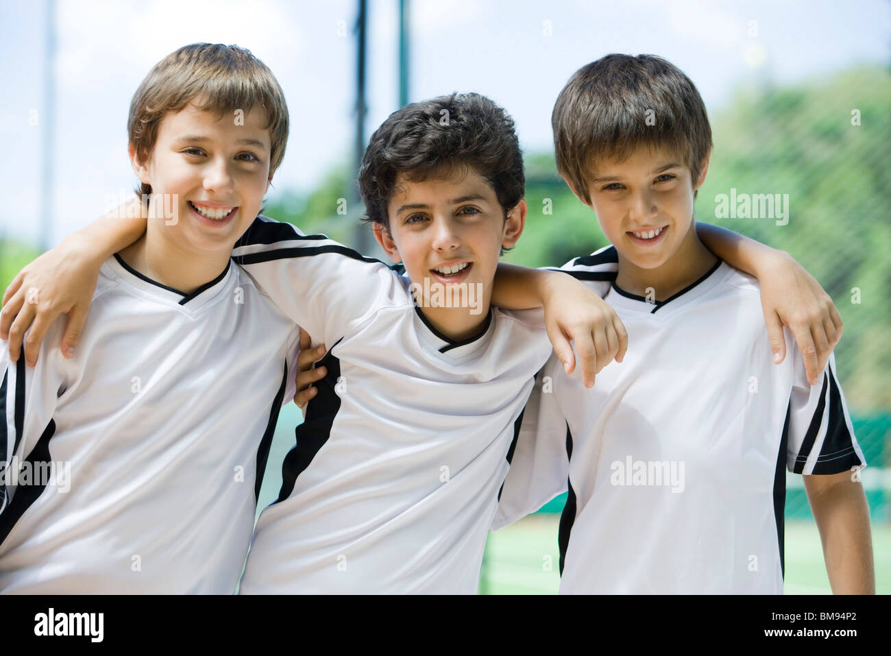Young friends with arms around each other's shoulders, portrait Stock ...