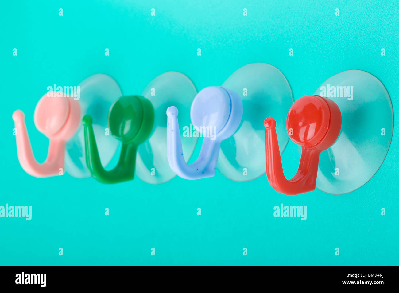 object on green - Colored plastic hook Stock Photo - Alamy