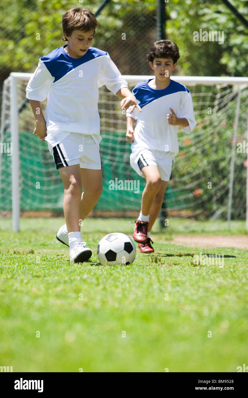 Children playing soccer, cropped Stock Photo - Alamy