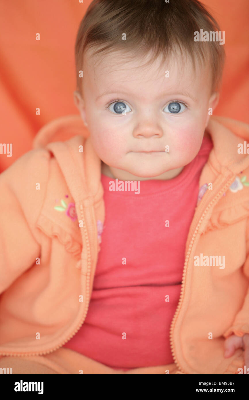 Baby In Orange Jacket Stock Photo - Alamy
