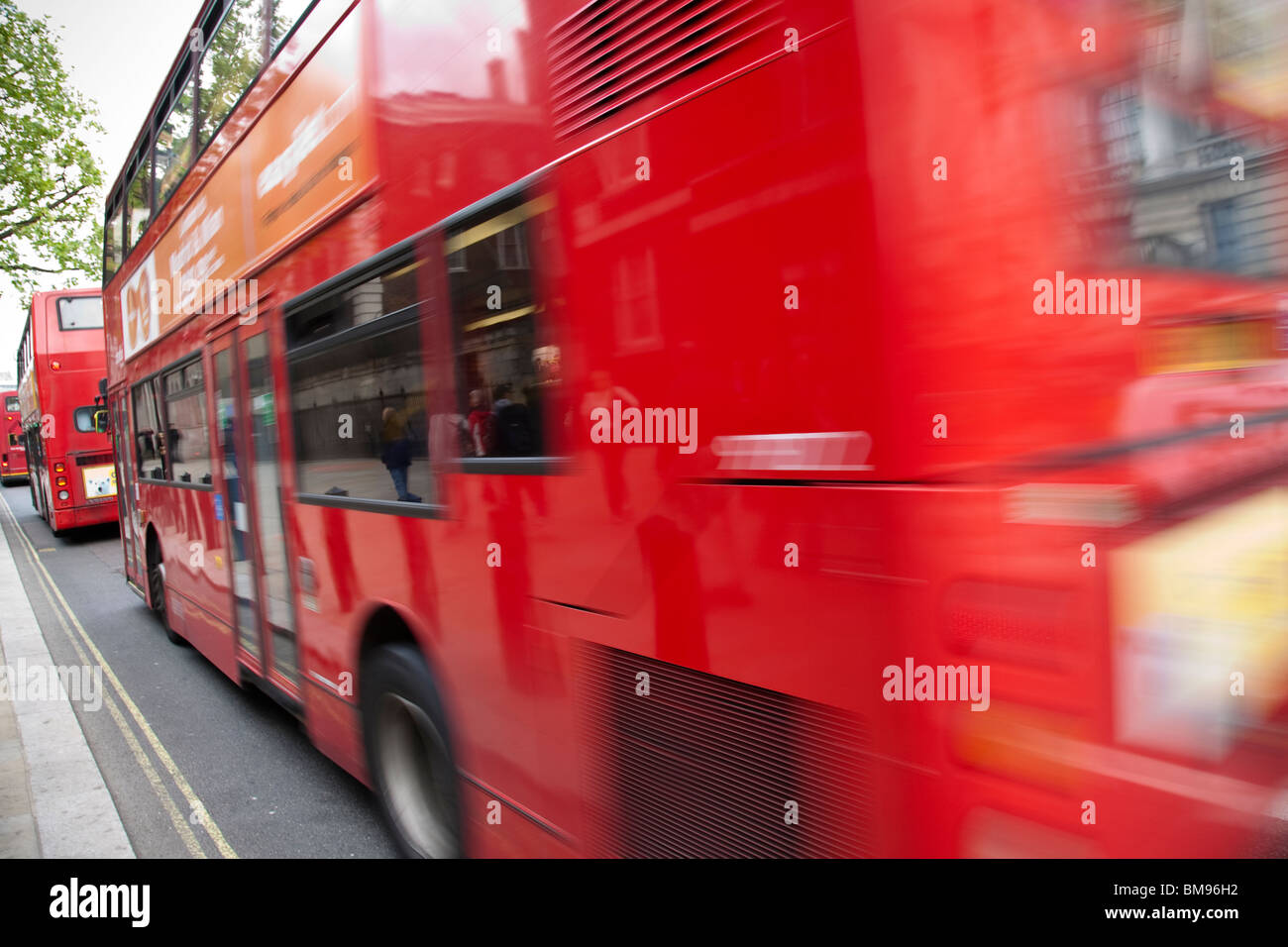 A line of red London buses queuing in Whitehall, London, England Stock ...