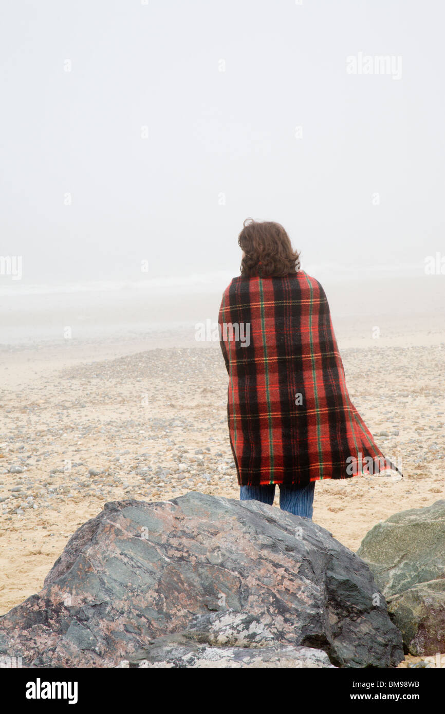 A woman stands, looking out over a foggy sea Stock Photo - Alamy