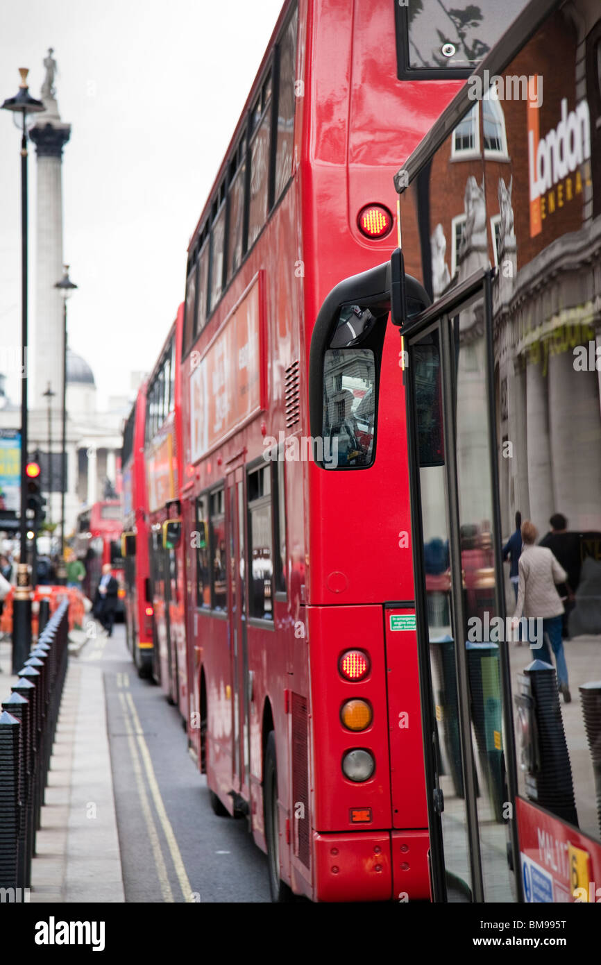 A line of red London buses queueing in Whitehall, London, England Stock ...