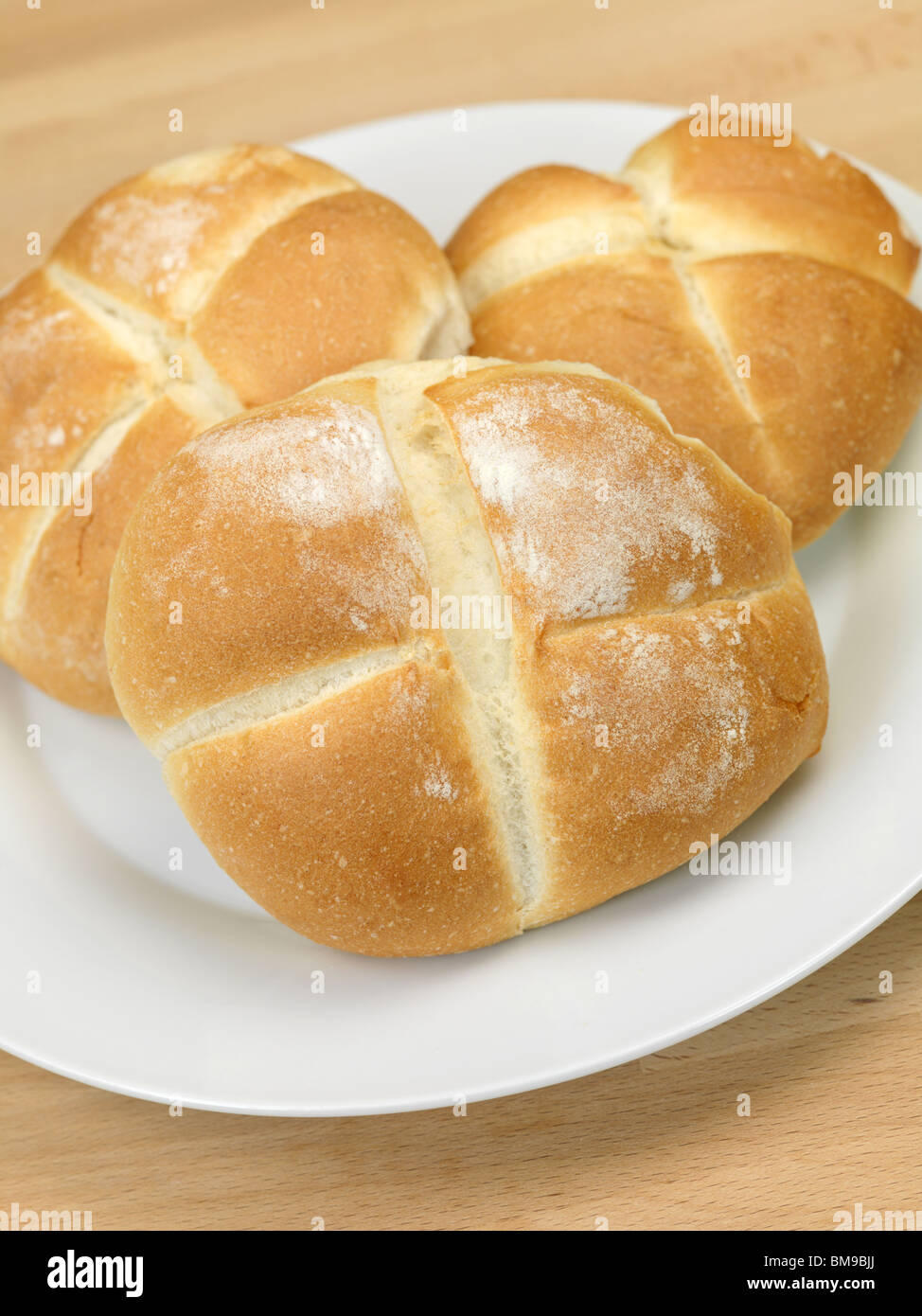 Fresh bread rolls isolated on a kitchen bench Stock Photo - Alamy