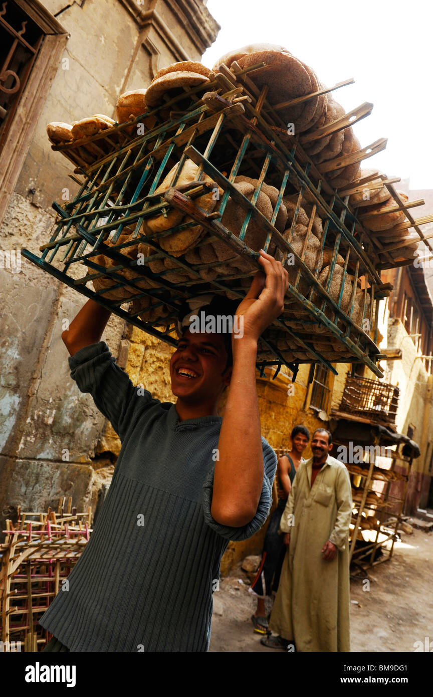 Man carrying bread on his head islamic Cairo Stock Photo - Alamy