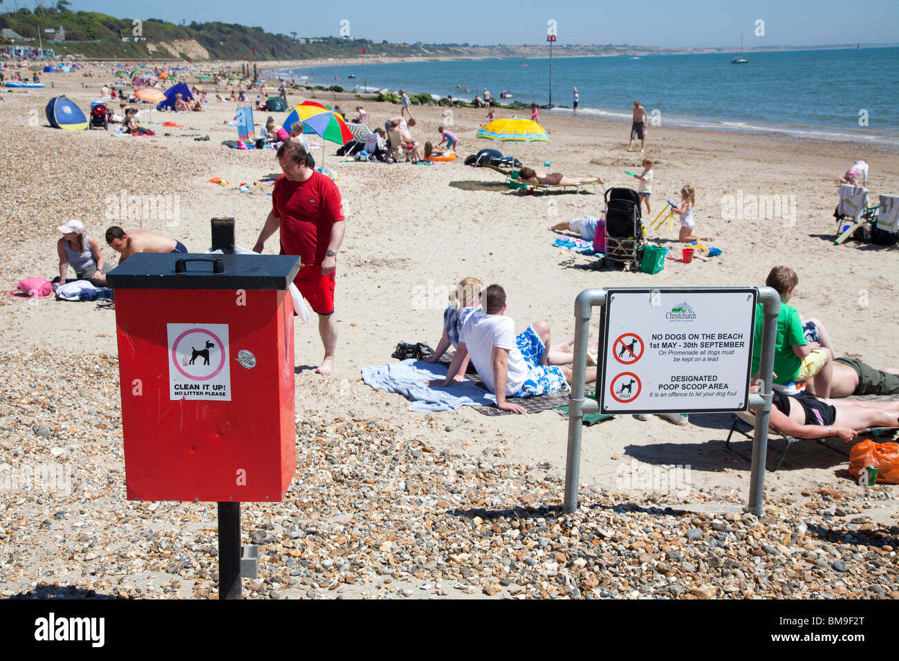 dog waste disposal bin and poop scoop sign on beach at mudeford Stock ...