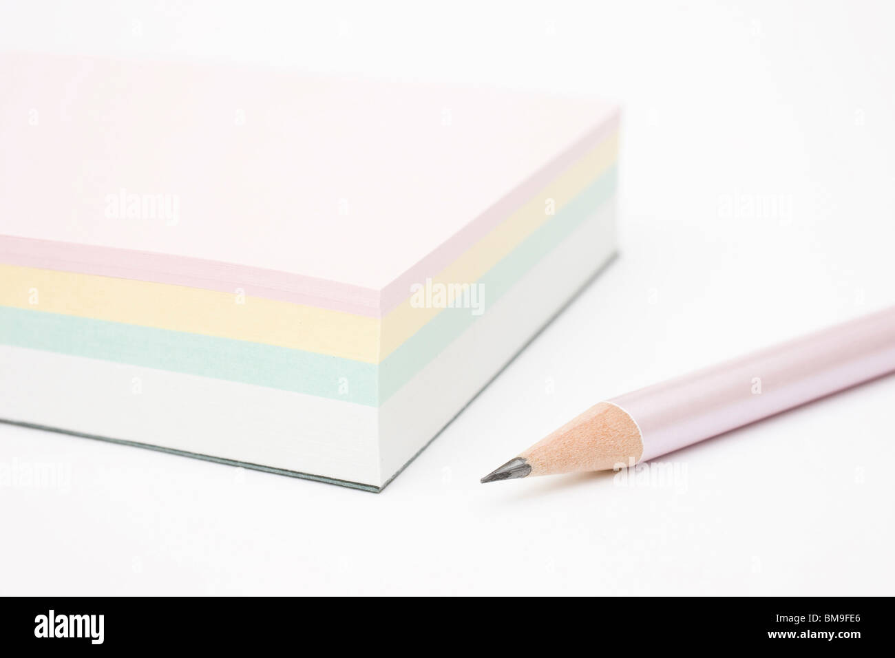 Pencil and note pad on white background, close up Stock Photo - Alamy