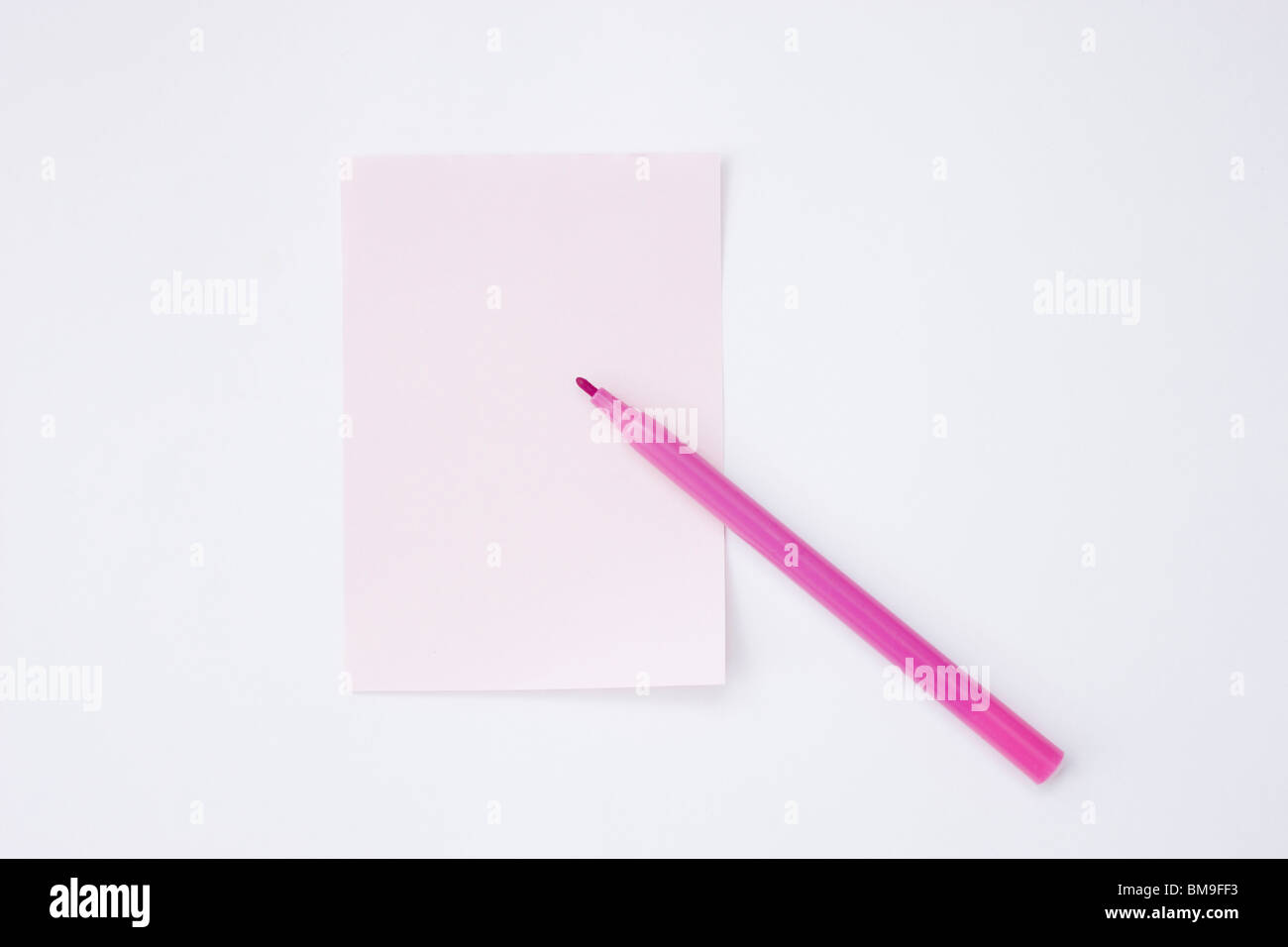 Pink pen and paper on white background Stock Photo - Alamy
