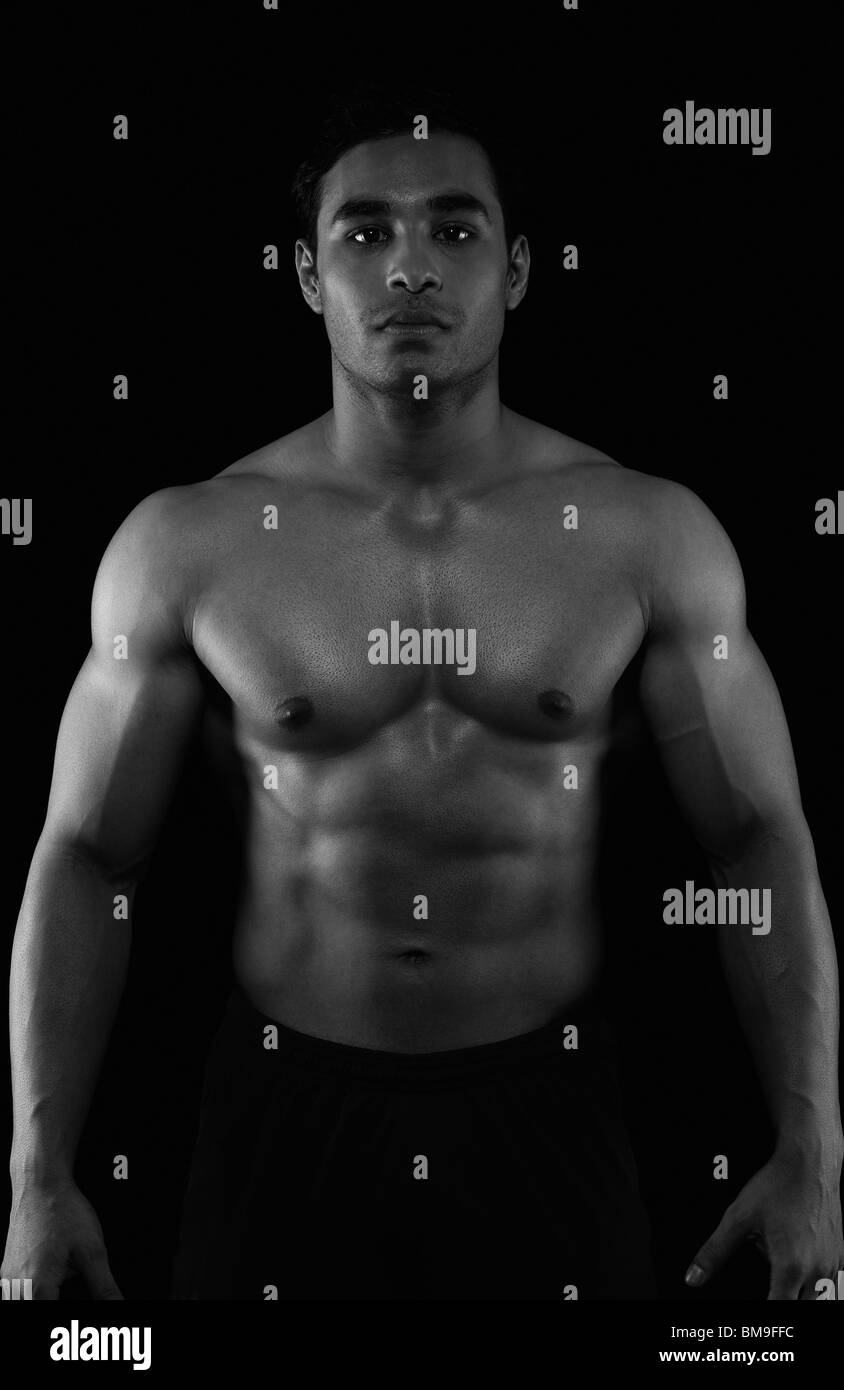 Portrait of a muscular man showing his abs Stock Photo - Alamy