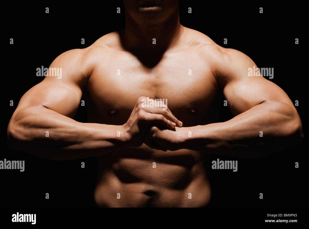 Close-up of a muscular man showing his muscles Stock Photo - Alamy