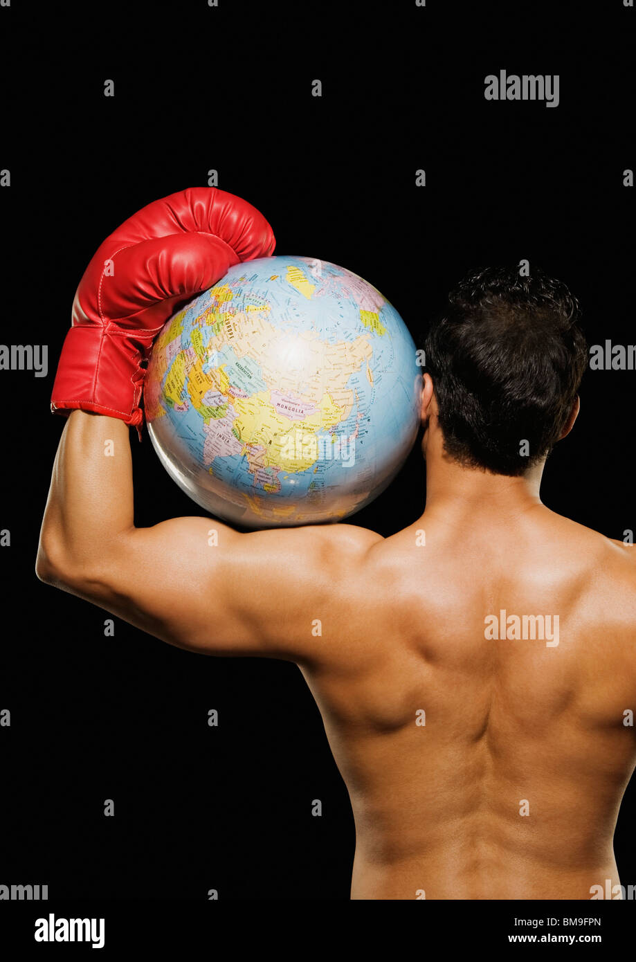 Male boxer holding a globe on his shoulder Stock Photo - Alamy