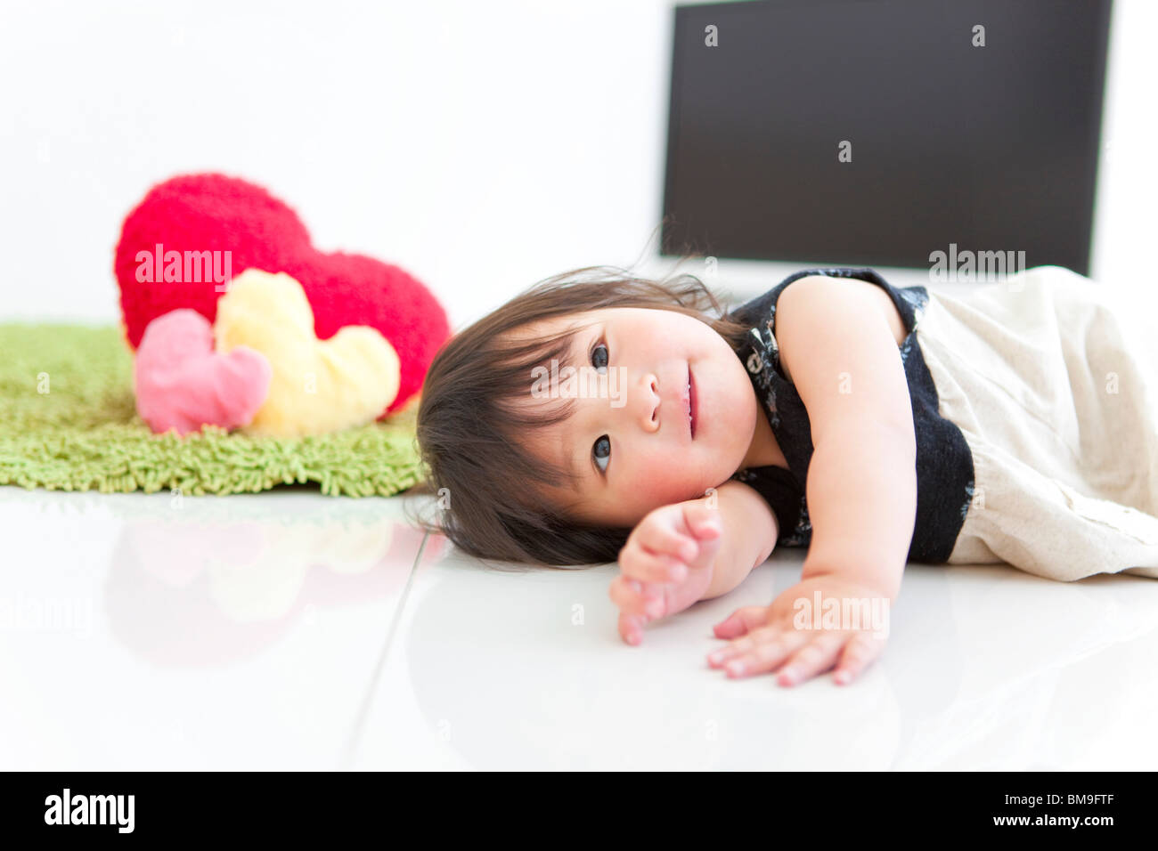 Baby girl lying on side Stock Photo - Alamy