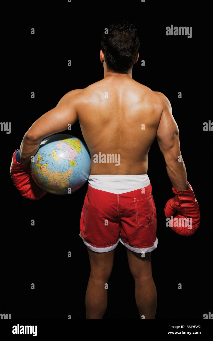 Rear view of a male boxer holding a globe Stock Photo - Alamy