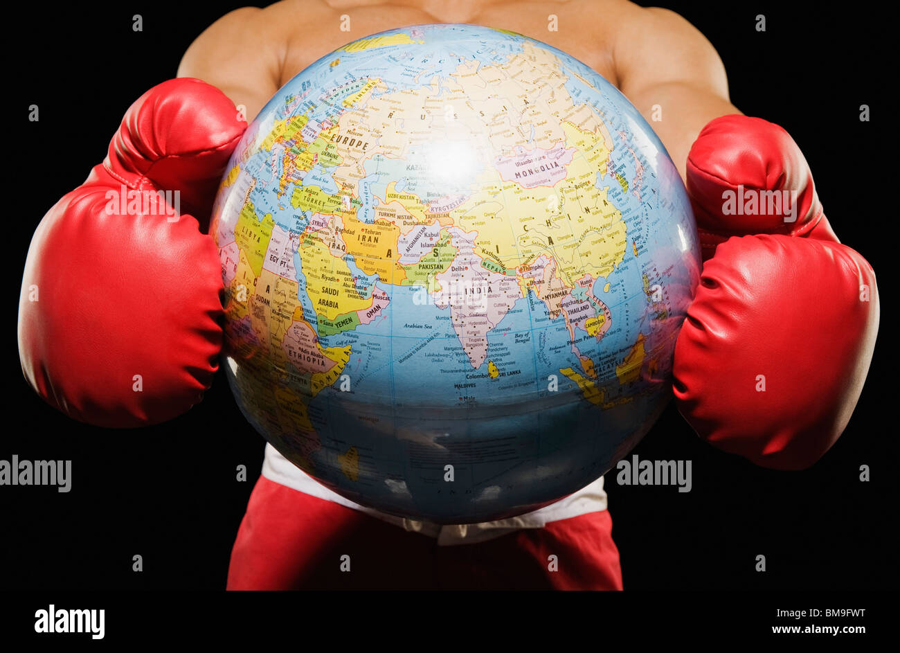 Mid section view of a boxer holding globe Stock Photo - Alamy