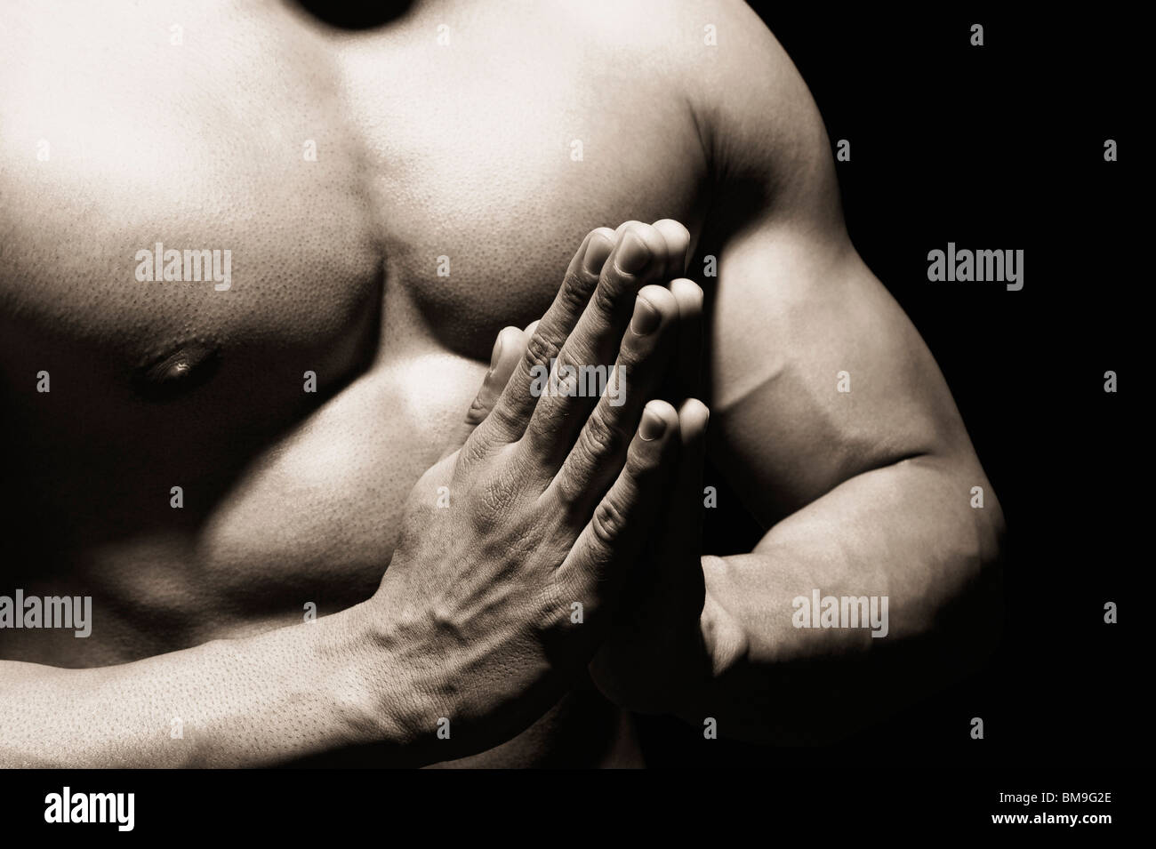 Mid section view of a muscular man meditating Stock Photo - Alamy