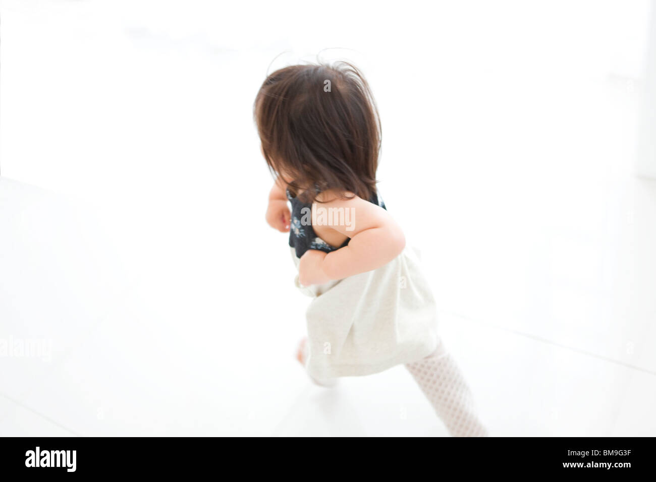 Baby girl walking Stock Photo - Alamy
