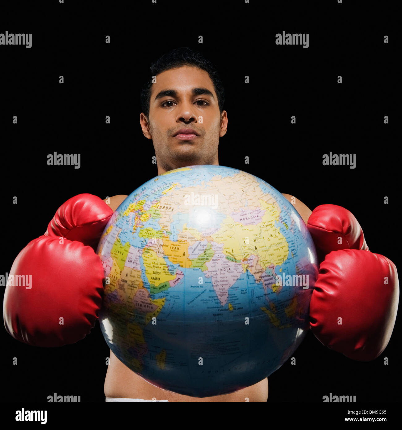 Portrait of a male boxer holding a globe Stock Photo - Alamy