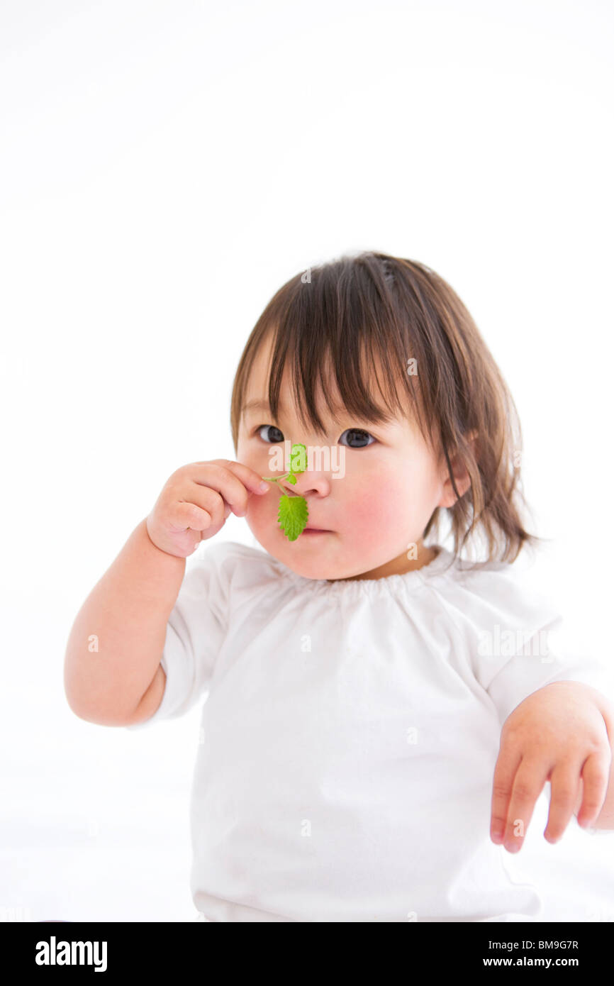 Baby girl holding sapling Stock Photo - Alamy