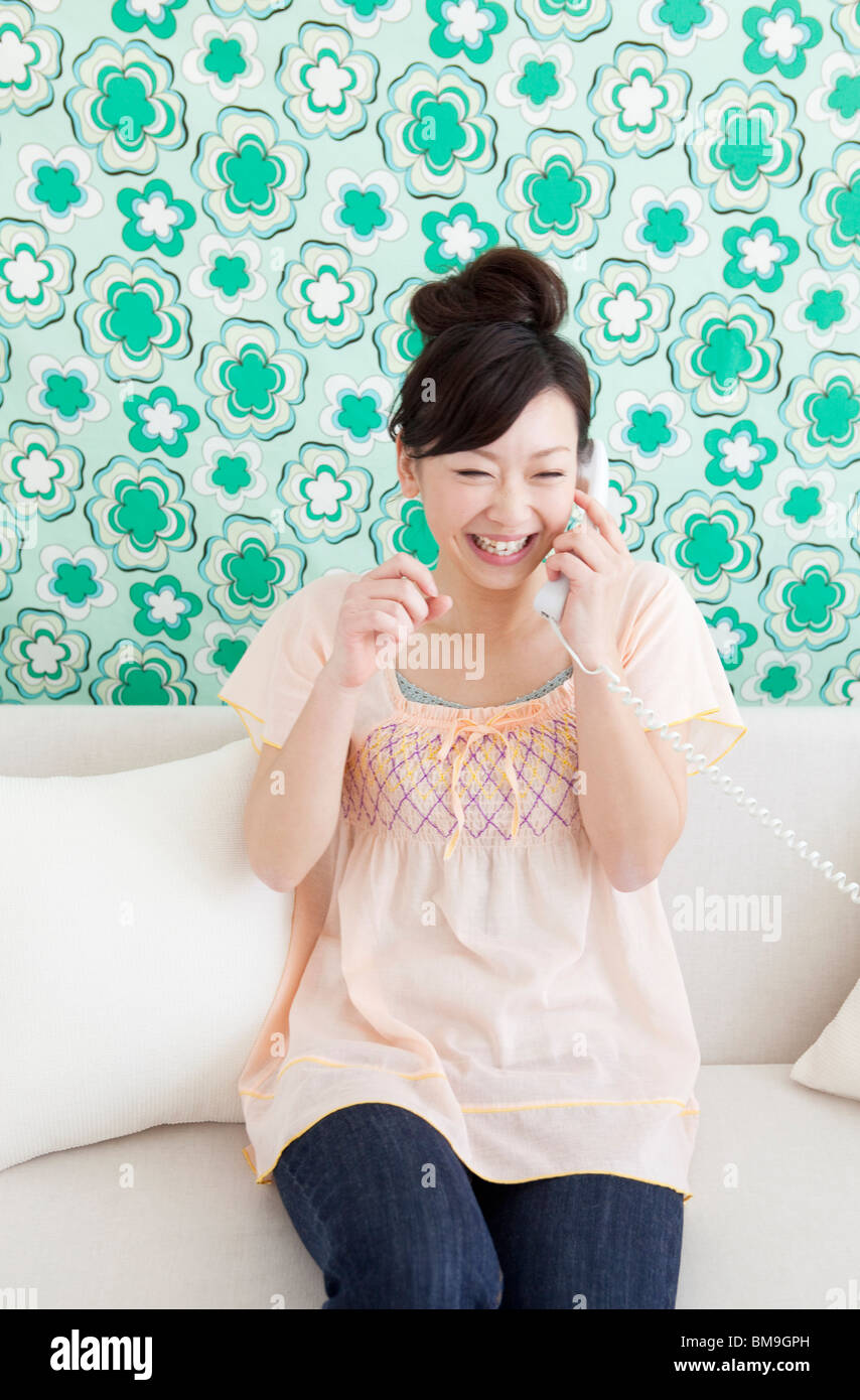 Young woman on telephone Stock Photo - Alamy