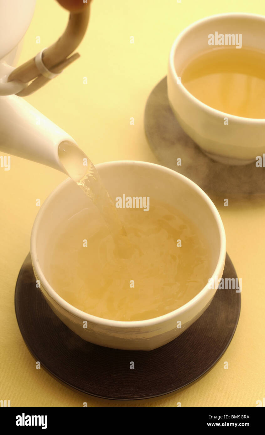 Two cups and pouring tea hi-res stock photography and images - Alamy