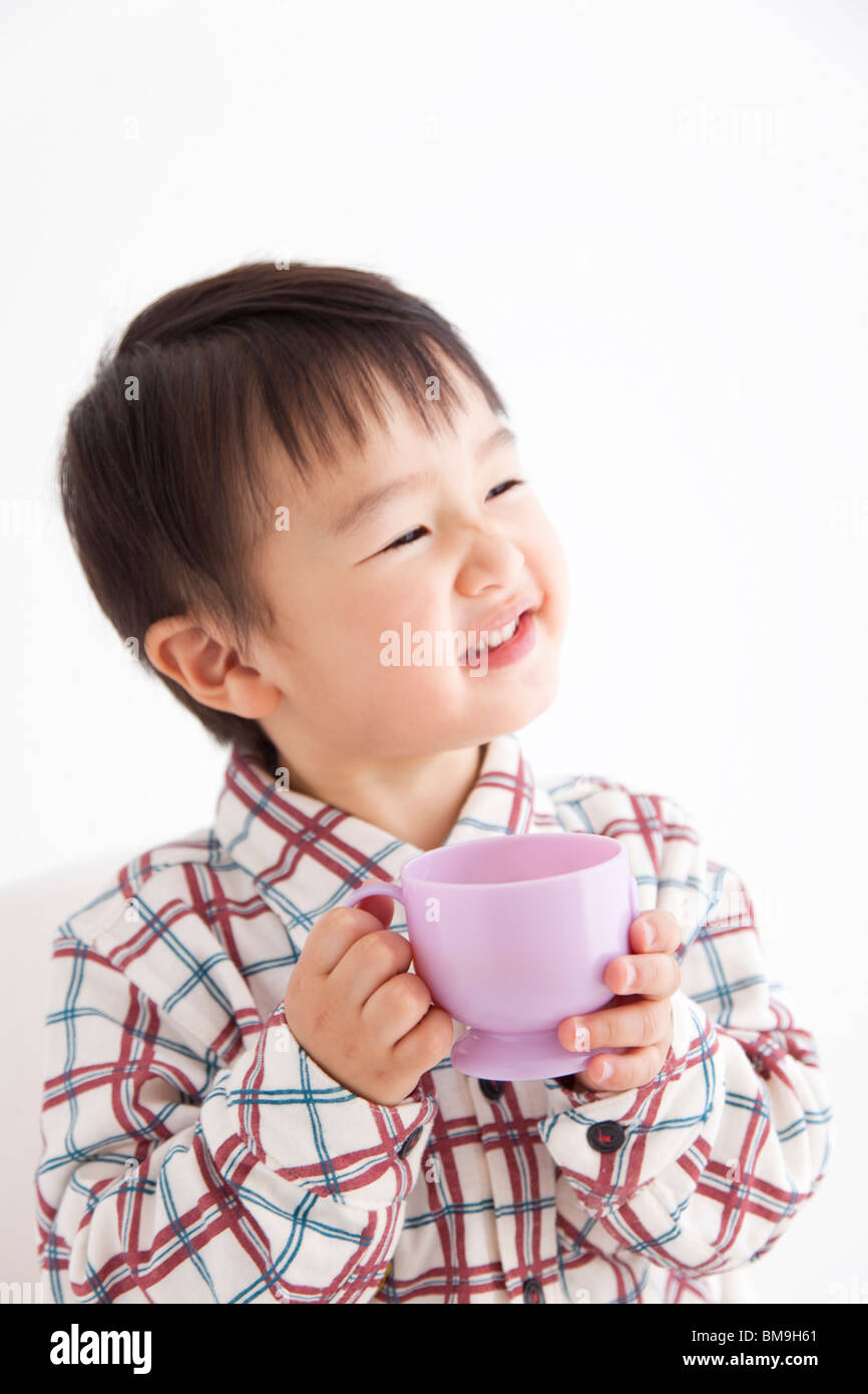 Boy drinking juice from a plastic cup Stock Photo - Alamy