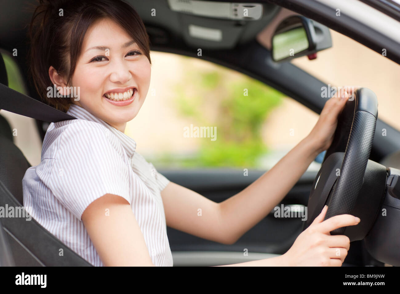 Portrait of young woman in car, smiling Stock Photo - Alamy