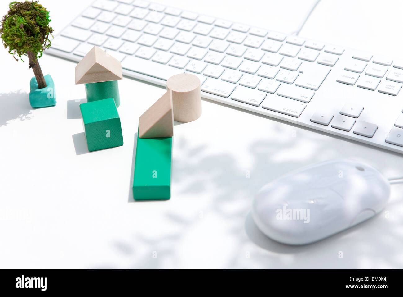 Wooden houses, computer keyboard and mouse on white background Stock ...