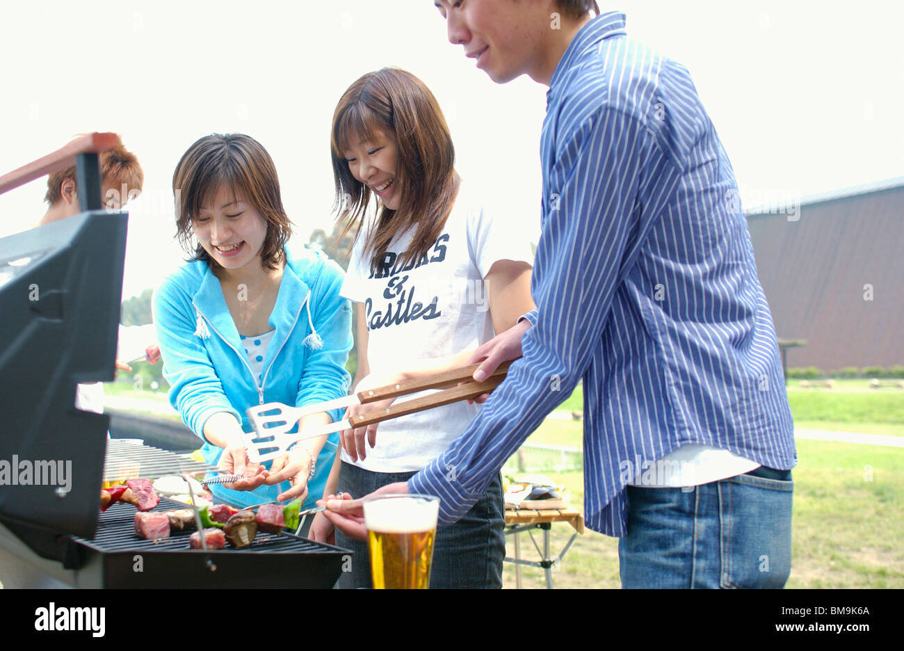 Young People Doing BBQ Stock Photo - Alamy