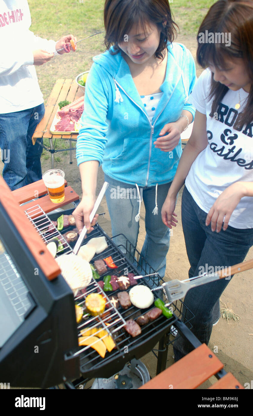 Young People Doing BBQ Stock Photo - Alamy