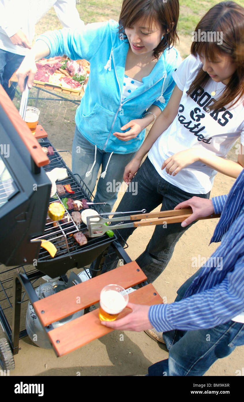 Young People Doing BBQ Stock Photo - Alamy