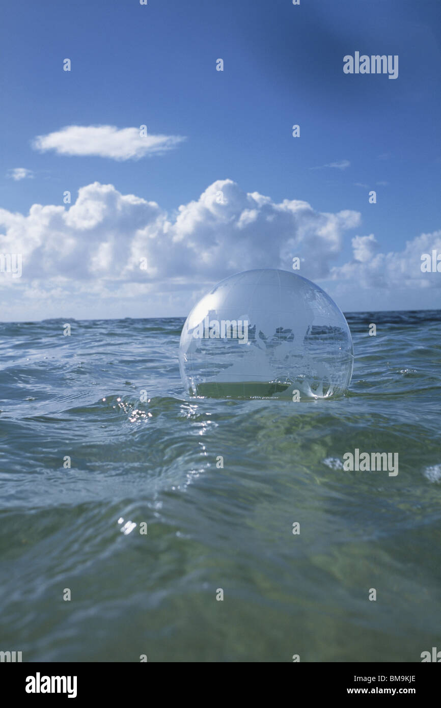 Globe beach ball floating on water Stock Photo - Alamy