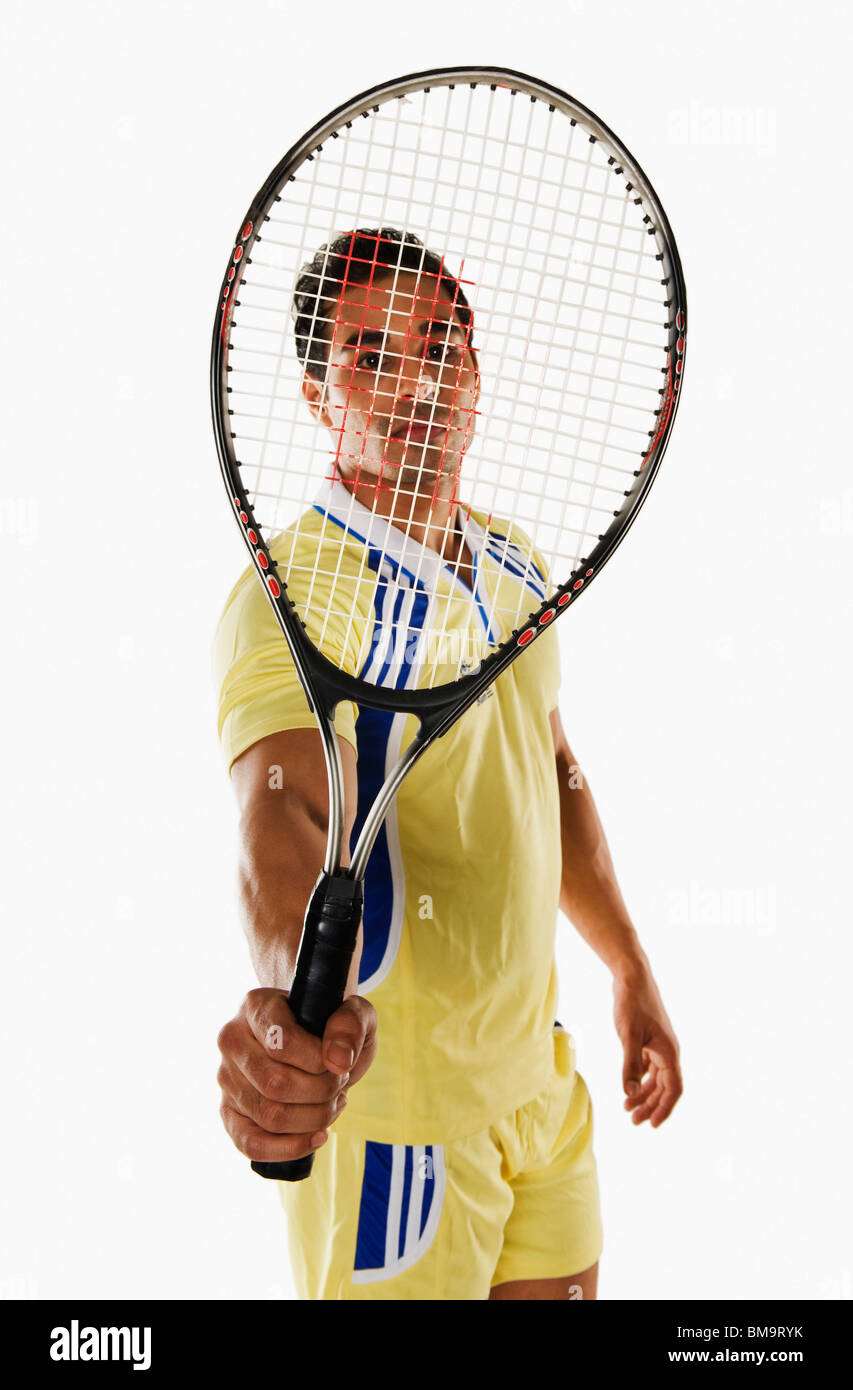 Man holding a tennis racket Stock Photo - Alamy