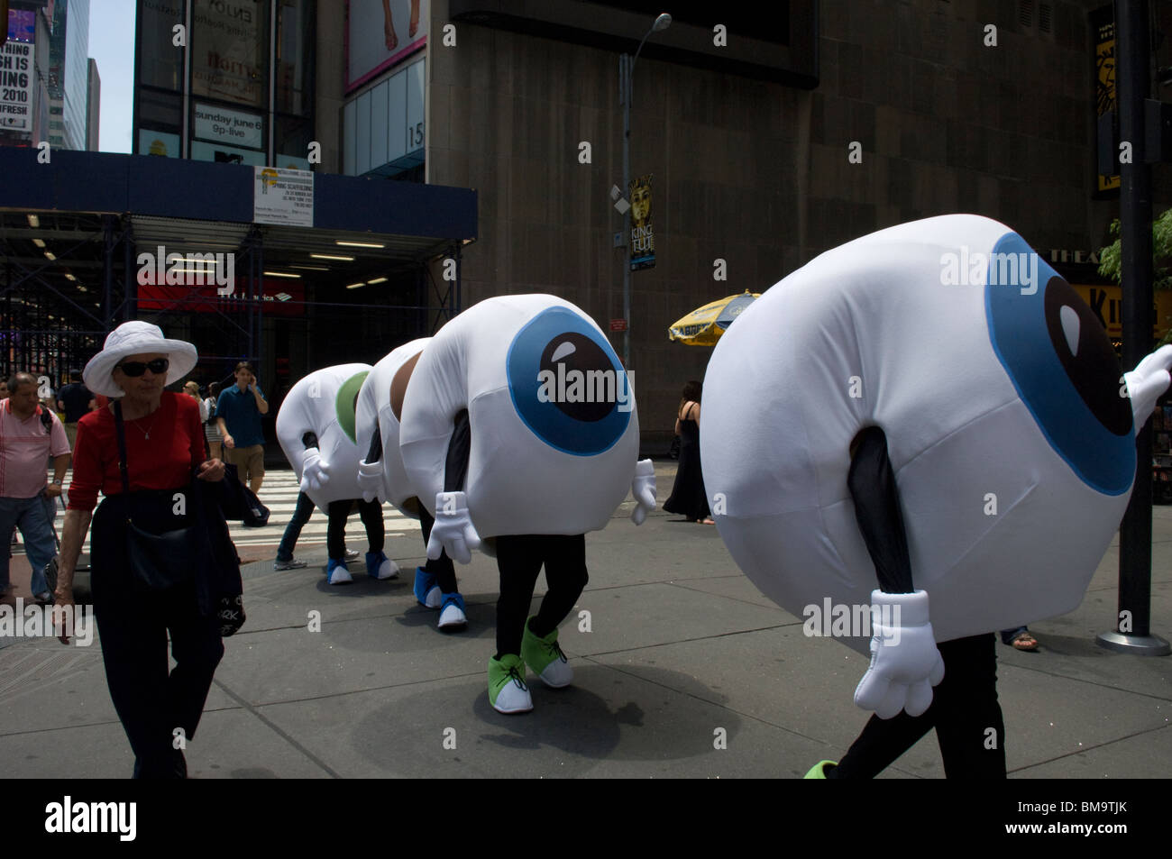 Dancers dressed in eyeball costumes dance and cavort in Times Square in ...