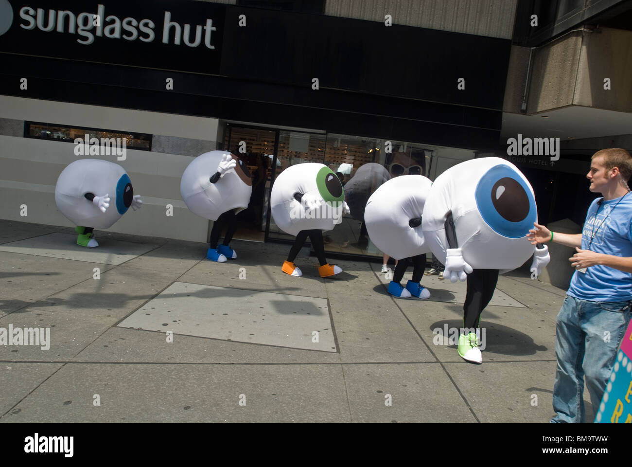 Dancers dressed in eyeball costumes dance and cavort in Times Square in ...