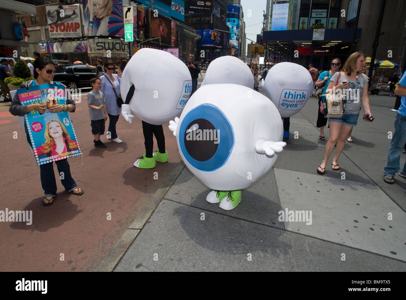 Dancers dressed in eyeball costumes dance and cavort in Times Square in ...