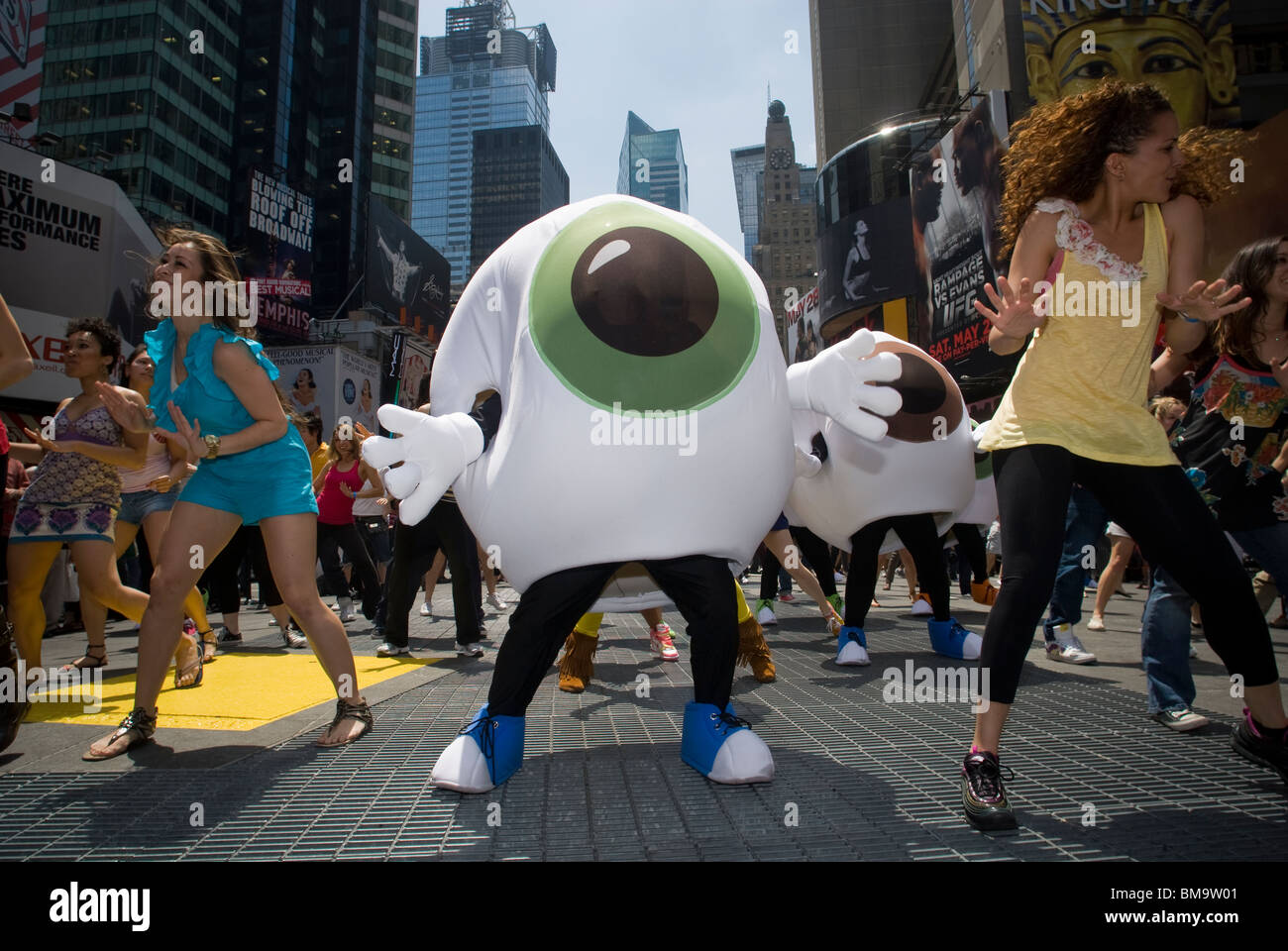 Dancers dressed in eyeball costumes dance and cavort in Times Square in ...