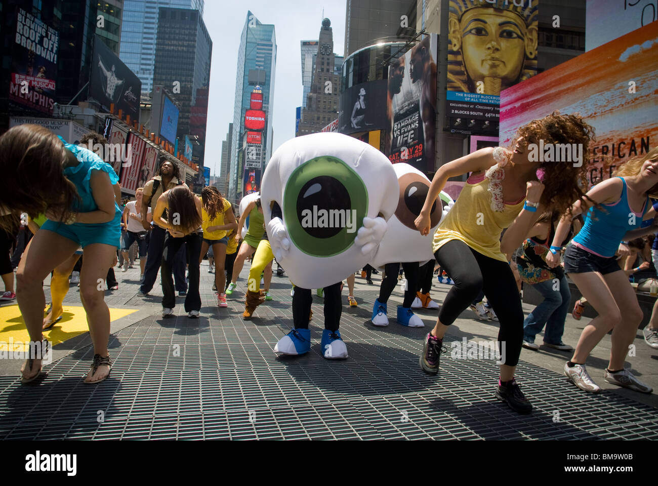 Dancers dressed in eyeball costumes dance and cavort in Times Square in ...