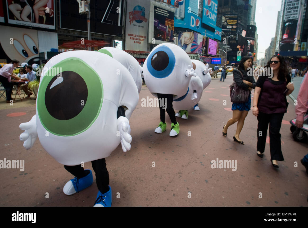 Dancers dressed in eyeball costumes dance and cavort in Times Square in ...
