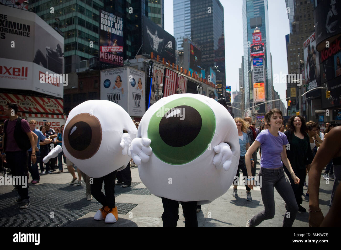 Dancers dressed in eyeball costumes dance and cavort in Times Square in ...