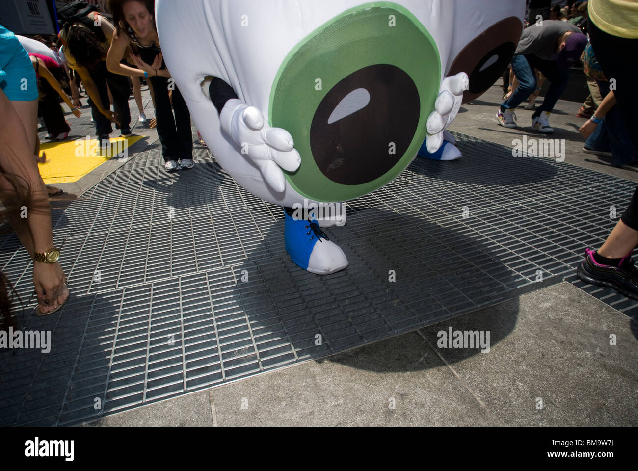 Dancers dressed in eyeball costumes dance and cavort in Times Square in ...