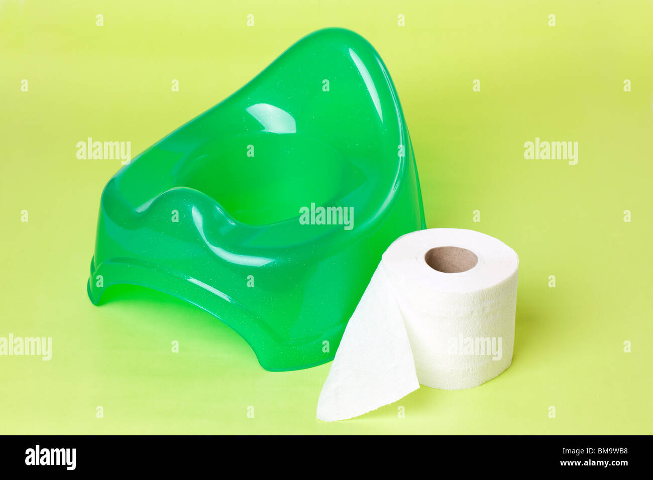 green potty with toilet paper Stock Photo - Alamy