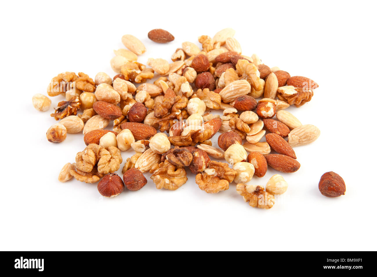 pile of raw mixed nuts isolated on white background Stock Photo - Alamy