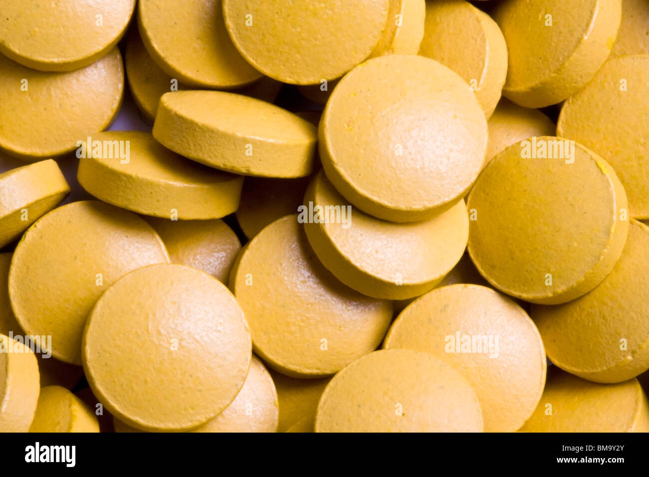 Yellow tablets closeup background Stock Photo - Alamy