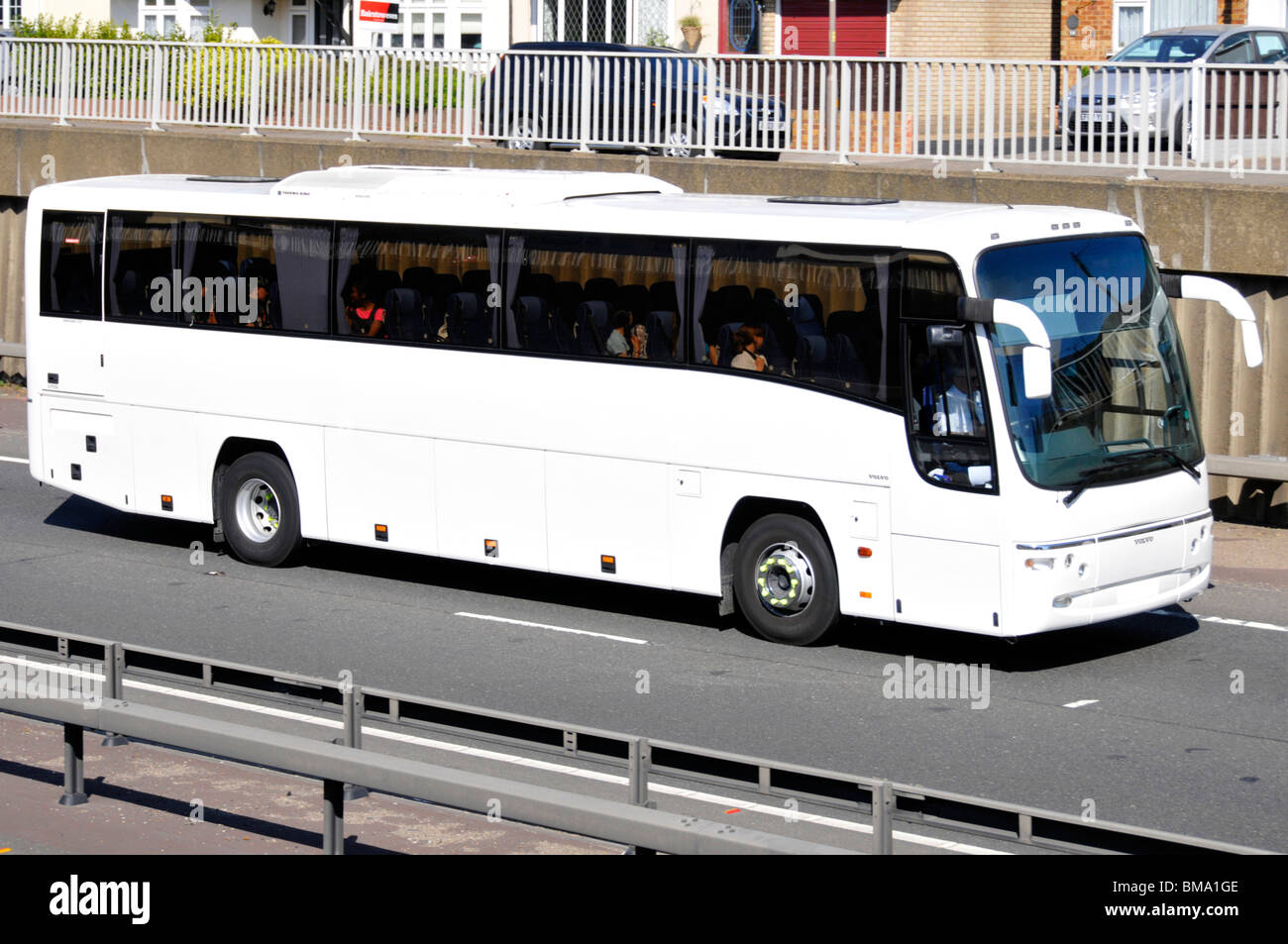 Unmarked clean white coach with obscured numberplate driving along A12 ...