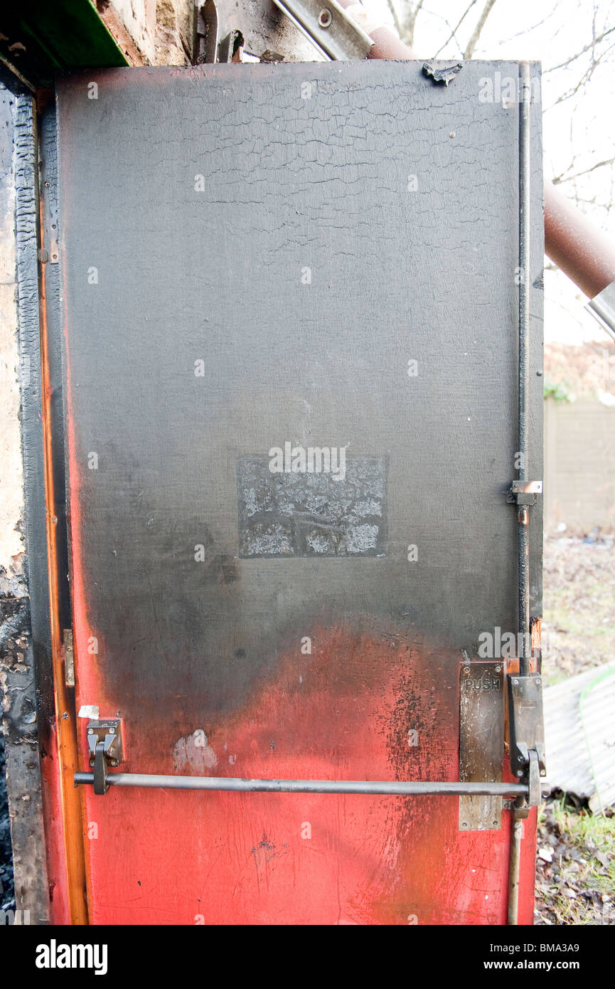 Fire exit door with fire and smoke damage Stock Photo - Alamy