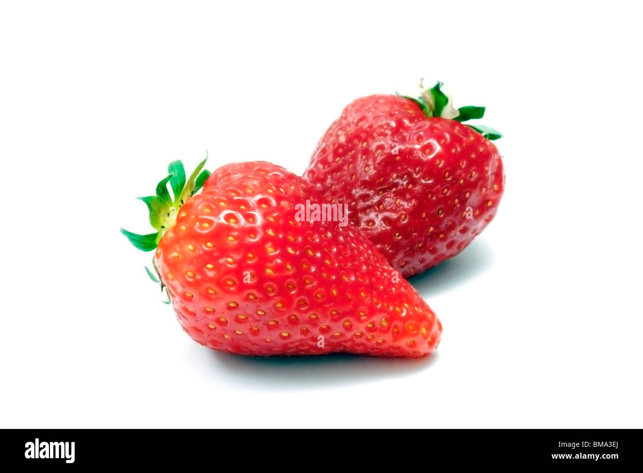 Two strawberries isolated on white background Stock Photo - Alamy