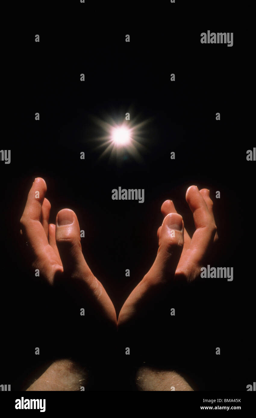 Hands reach for a light Stock Photo - Alamy
