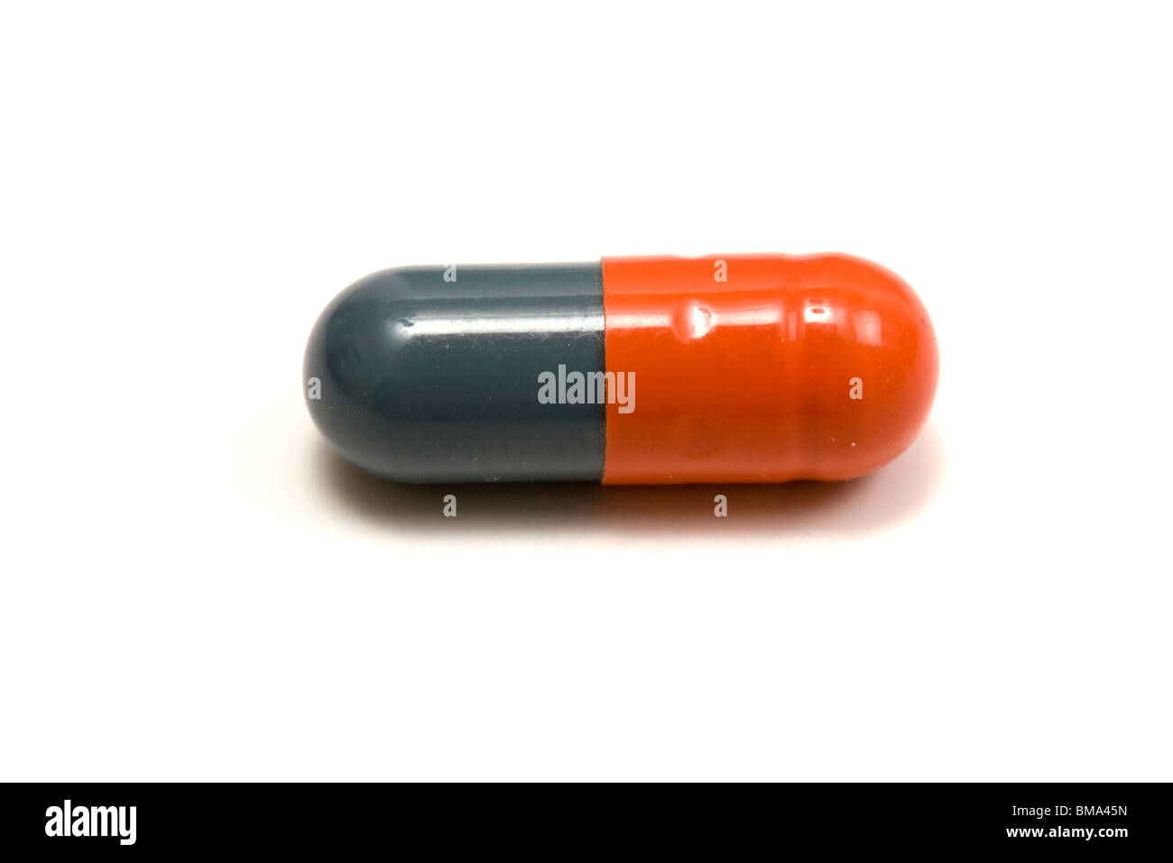 A capsule isolated on white background Stock Photo - Alamy