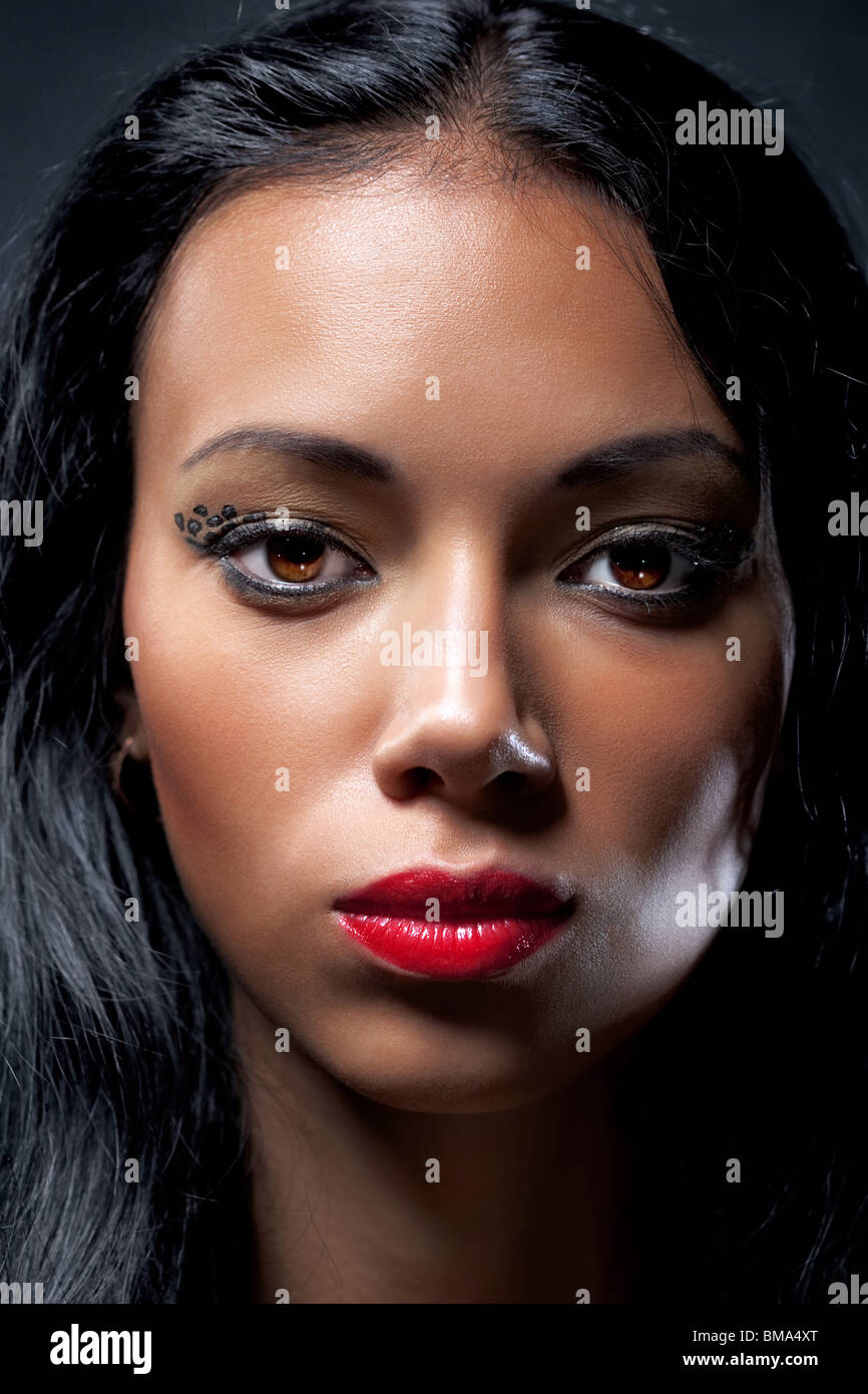 Young brunette woman portrait. Dark contrast colors Stock Photo - Alamy